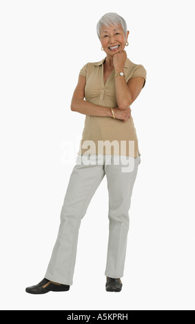 Full body shot of mature Asian businesswoman with Wai as Thai greeting ...