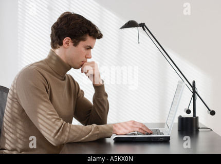 Businessman hand typing on laptop with reports and graphs concept ...