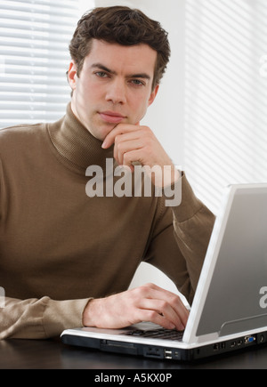 Portrait of a man next to the desk Stock Photo - Alamy