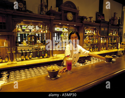 Inside the famous Raffles Long Bar, Singapore showing a traditional bag ...