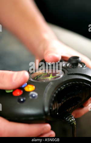 A PERSONS HANDS PLAYING A GAMES CONSOLE JOYPAD Stock Photo - Alamy