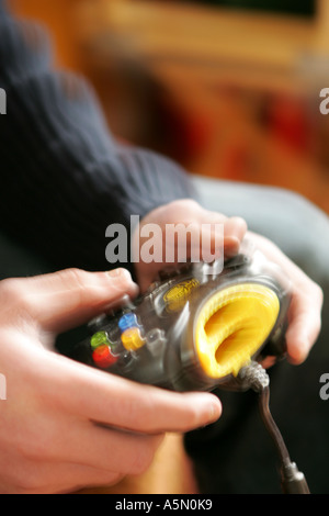 A PERSONS HANDS PLAYING A GAMES CONSOLE JOYPAD Stock Photo - Alamy
