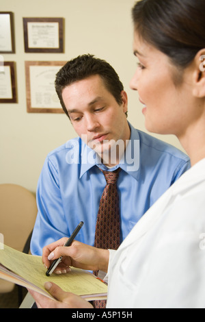 Health professional answers questions Stock Photo - Alamy