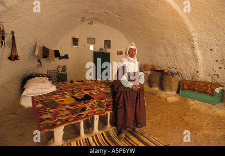 Berber woman in bedroom of Berber troglodyte underground homestead ...