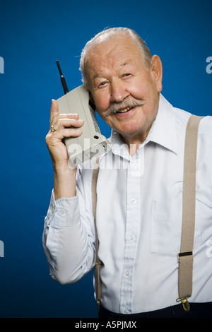 Older man making call on retro wireless phone Stock Photo - Alamy
