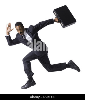 Young businessman holding briefcase and running Stock Photo - Alamy
