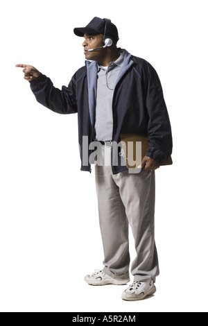 Male head coach pointing finger with headset Stock Photo - Alamy