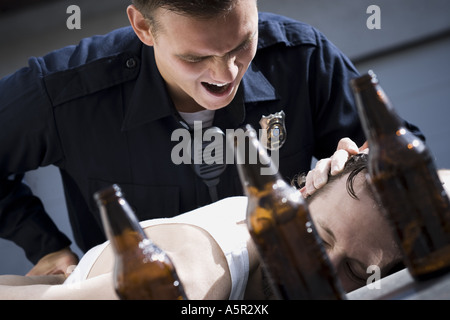 Police officer arresting man lying down with handcuffs Stock Photo - Alamy