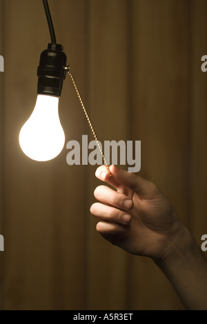Man pulling light switch Stock Photo - Alamy