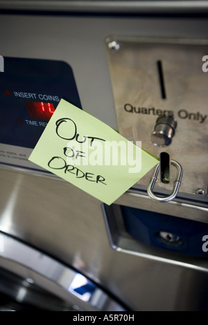 Out of order sign on Laundromat machine Stock Photo - Alamy