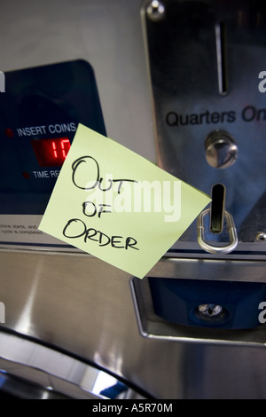 Out of order sign on Laundromat machine Stock Photo - Alamy