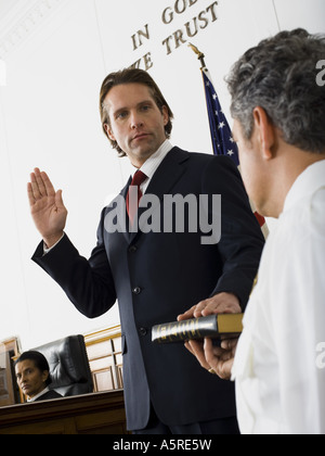 Witness swearing over the Bible Stock Photo - Alamy