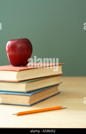 Red apple with school books on table in classroom Stock Photo - Alamy