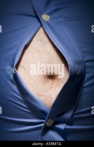 Close up of fat stomach bursting through shirt Stock Photo - Alamy