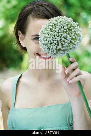Woman with stalk of allium Stock Photo - Alamy