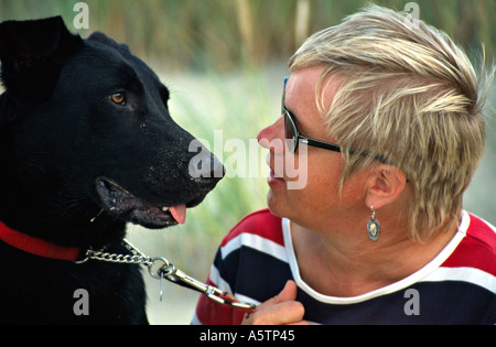 MR PR woman and a dog communicating Stock Photo - Alamy