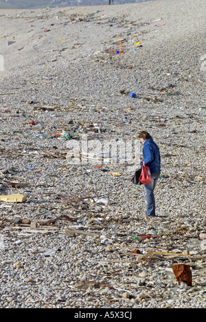 woman beachcombing chesil beach dorset england uk gb eu Stock Photo - Alamy