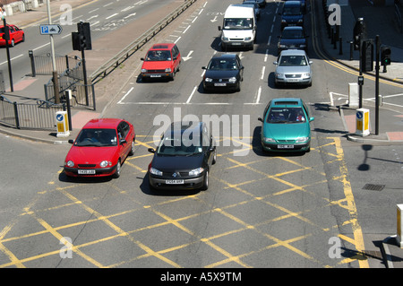 Cars in a yellow box junction in Cardiff, UK. Cameras have been Stock ...