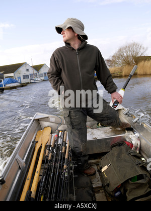 Man fishing for Pike while on a Norfolk broads boating holiday Stock ...
