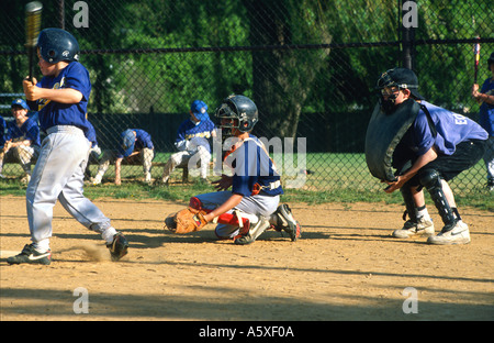 Baseball Catcher behind home plate. Shot from behind a chain link fence ...