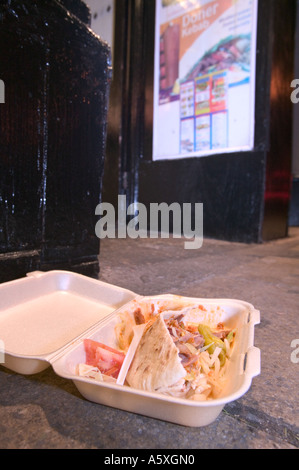 a half eaten kebab discarded on the pavement outside a kebab shop in ...