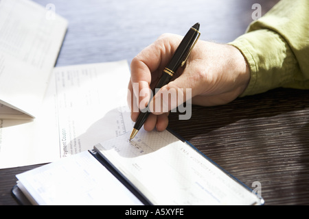Male caucasian hands writing check to Internal revenue service IRS ...