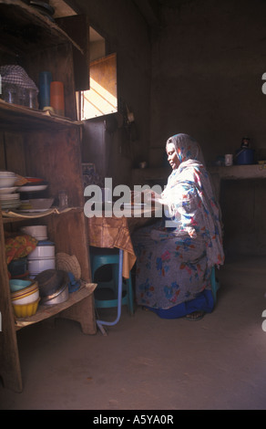 Sudanese woman in the kitchen wearing the traditional dress called Tob ...