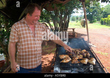 A man grilling chicken in Argentina Stock Photo - Alamy
