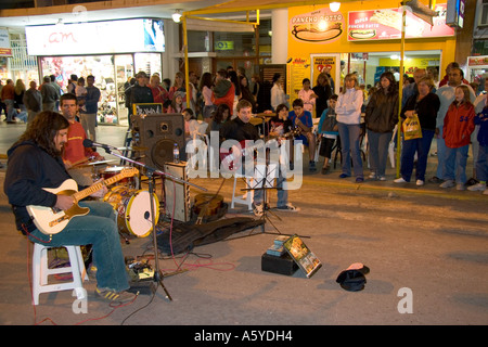 Street musicians play music on a sidewalk in northern Tehran, Wednesday ...