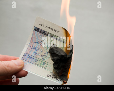 hand holding a burning cheque eurocheque Stock Photo - Alamy