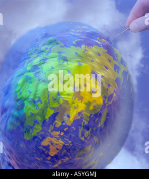 man destroying the earth hand with a needle pricking into burning earth ...