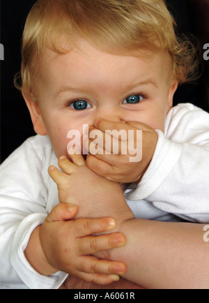 Baby girl chewing her feet Stock Photo - Alamy