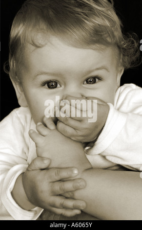 Baby girl chewing her feet Stock Photo - Alamy