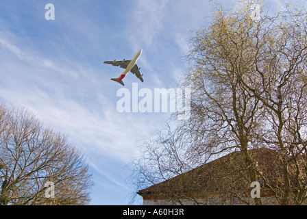 Aeroplane flying close to buildings Stock Photo - Alamy