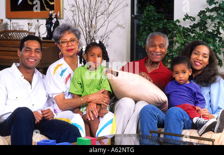 Three generations family portrait enjoying watching childhood picture ...