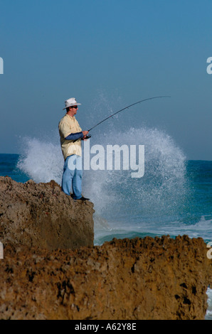 Man fishing on limestone shoreline of Hutchinson Island Stuart Martin ...
