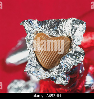 Heart shape chocolate with foil wrapper isolated on white Stock Photo ...