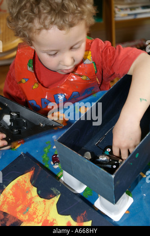 4 yr old boy building rocket Stock Photo - Alamy