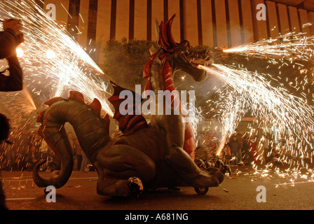Fallero wearing dragon costume with torches parades in the Cavalcada ...