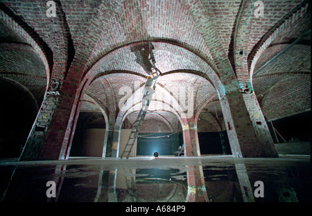 An electrician installying lights in Victorian Gothic style brick ...