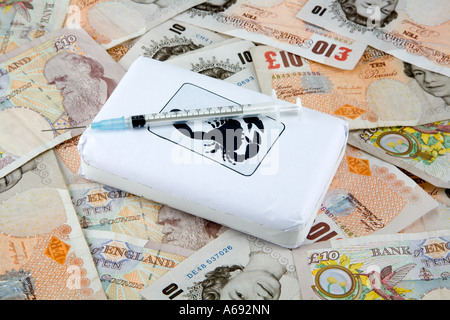 Packaged drugs with cash and syringe Stock Photo - Alamy