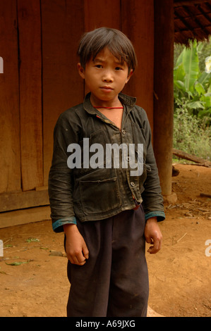 A Blue Hmong indigenous boy wearing traditional cloth proudly stands in ...