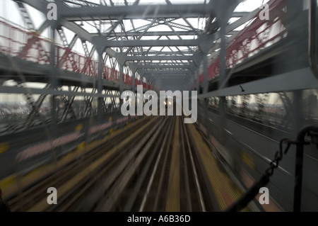 Williamsburg Subway bridge grid metal pillars commuters train station metro NY struts window ...