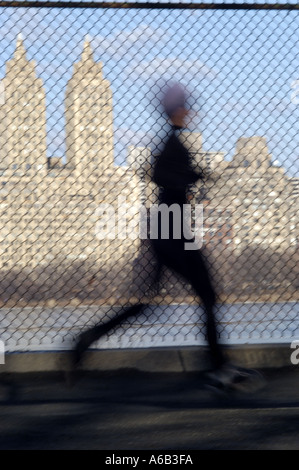 Jogger running alongside the Central Park Reservoir Stock Photo - Alamy