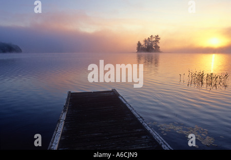 Canada Ontario Mackay Lake sunrise at dawn with wooden pier and island ...