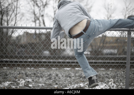 Man jumping over fence Stock Photo - Alamy