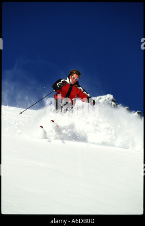 Skier carving a turn in deep fresh powder Stock Photo - Alamy