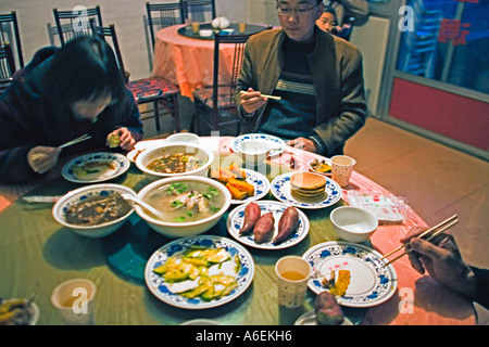 CHINA SIMATAI Chinese family eating shared dinner in rural village near ...