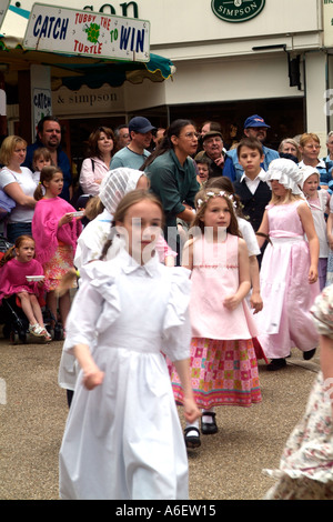 School children perform a Maypole dance routine dressed in traditional ...
