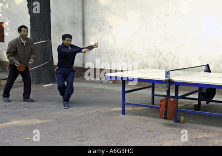 Playing ping pong in a neighborhood park in Beijing, China Stock Photo ...